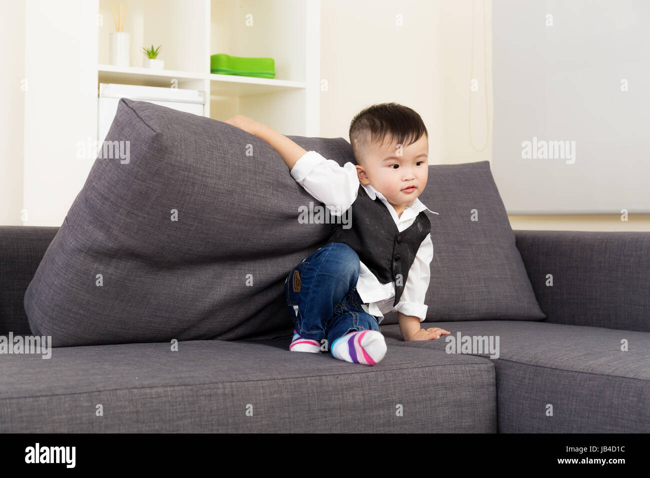 Little boy seating on sofa Stock Photo - Alamy