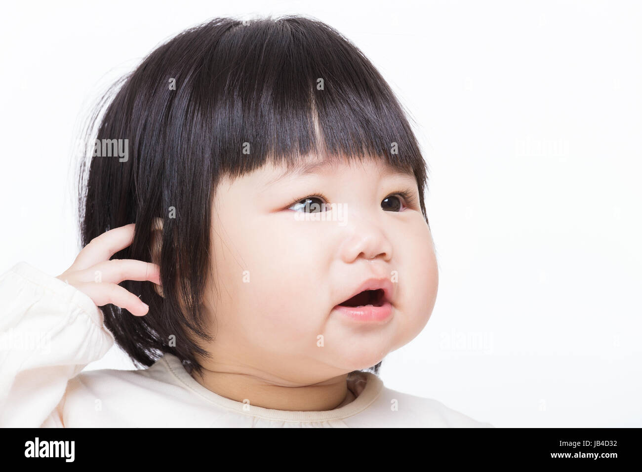 Baby scratching head Stock Photo - Alamy
