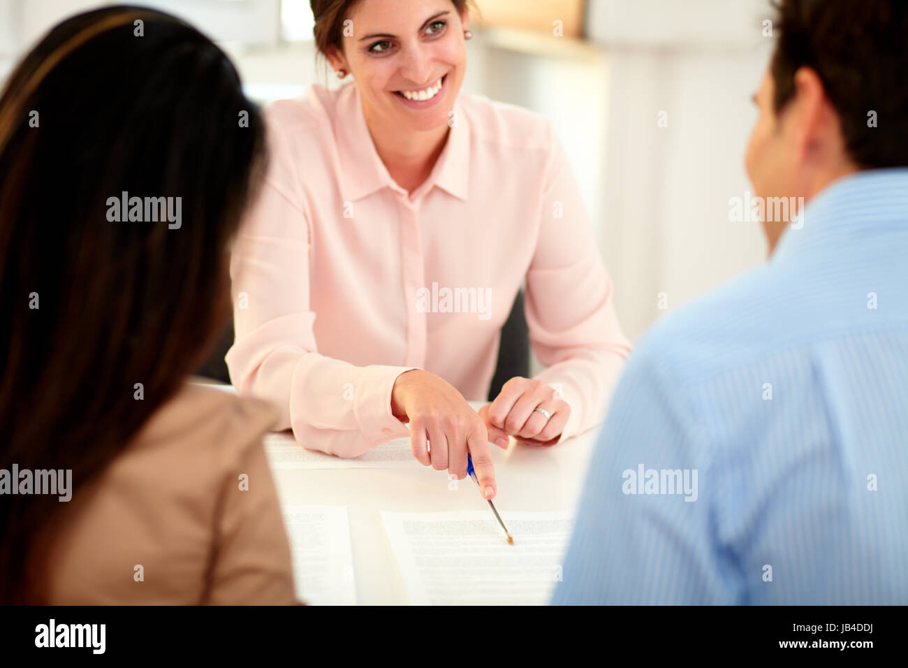 Portrait of young caucasian bank manager working on agreement contract ...