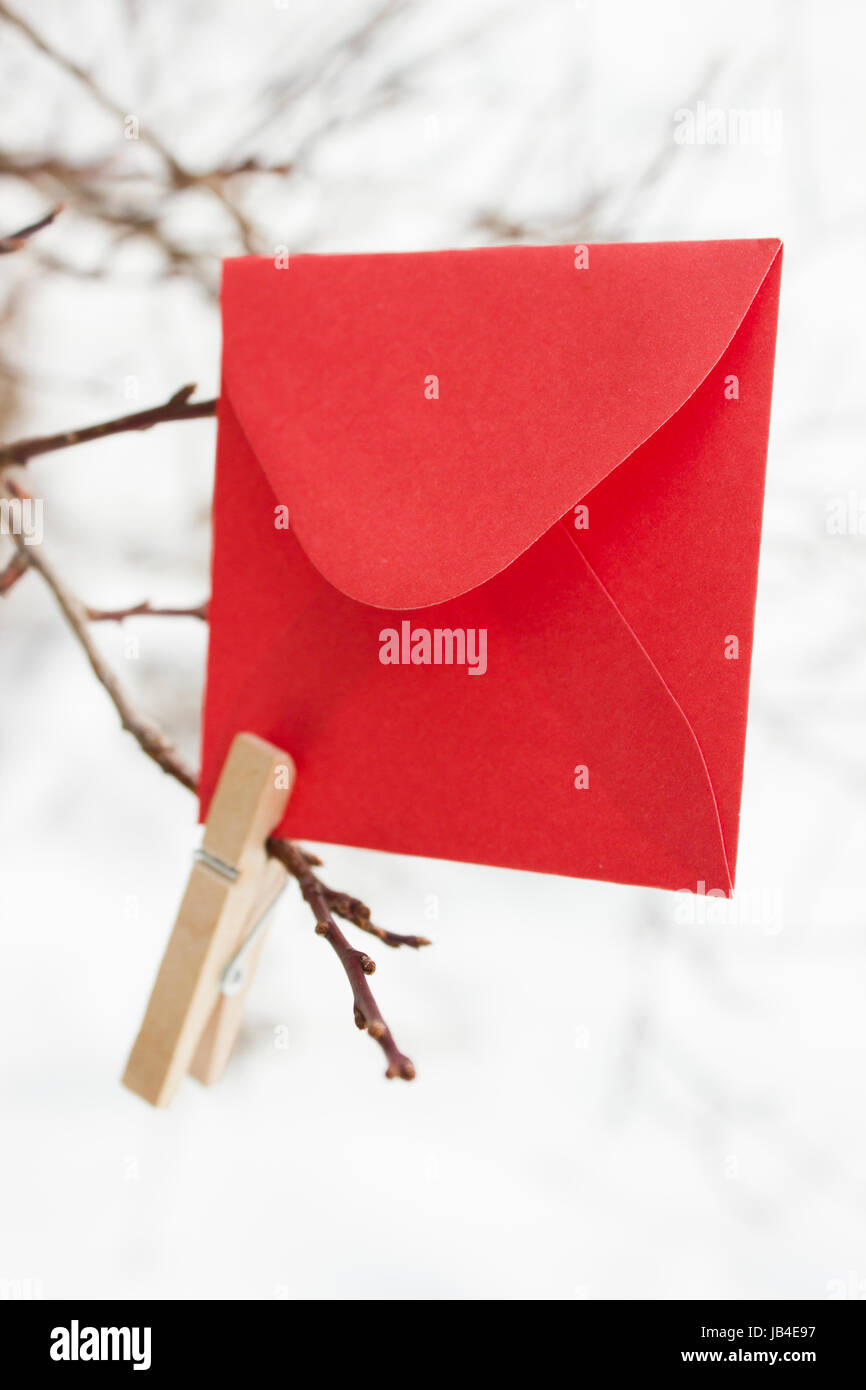 Red envelope pinned to a tree branch with snowy background Stock Photo ...