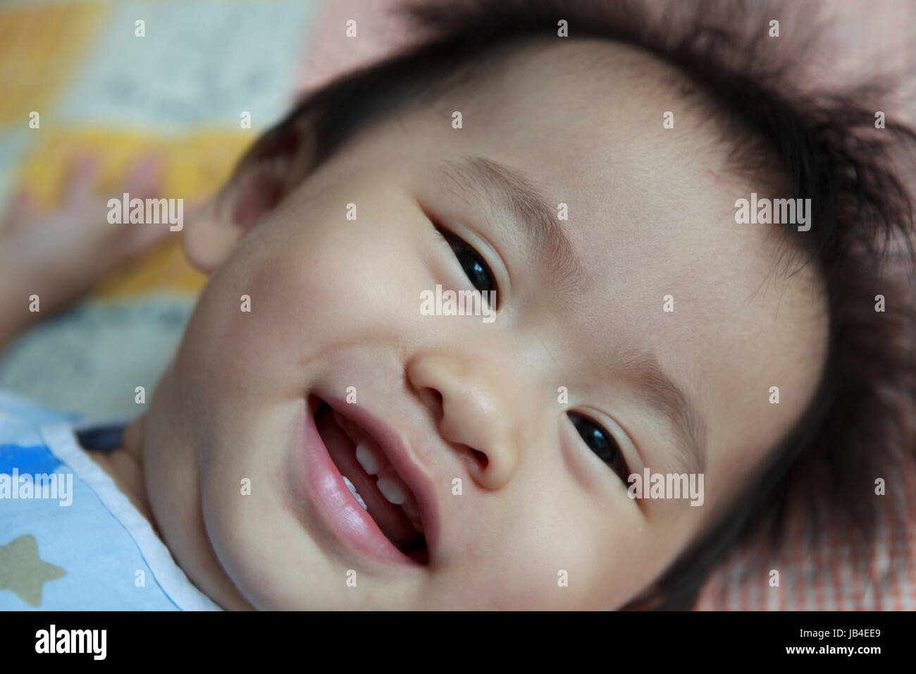 asian baby show four teeth in mouth Stock Photo - Alamy