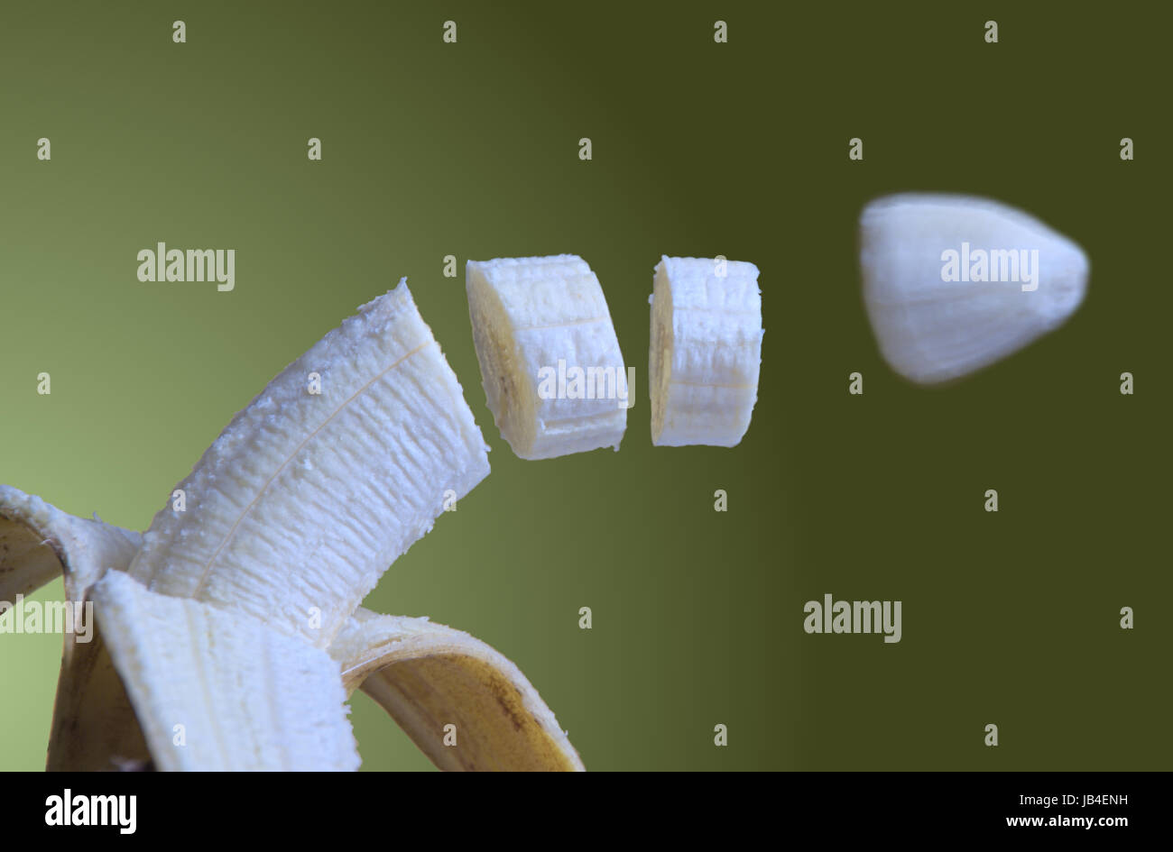 The image shows a banana with flying banana pieces Stock Photo - Alamy
