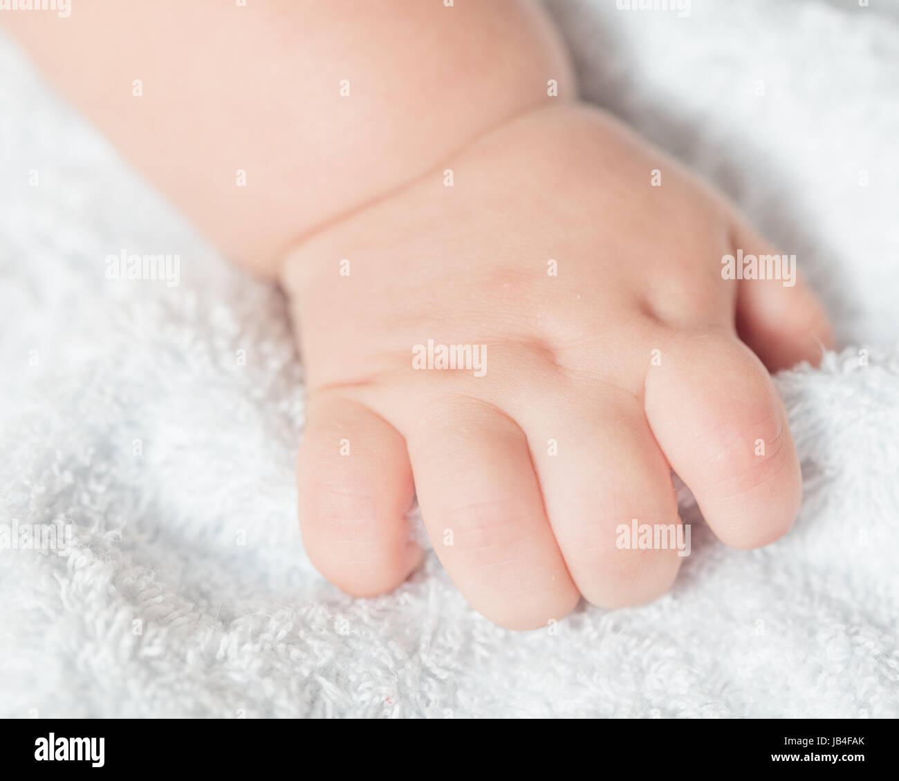 Hand of a baby on terry background Stock Photo - Alamy