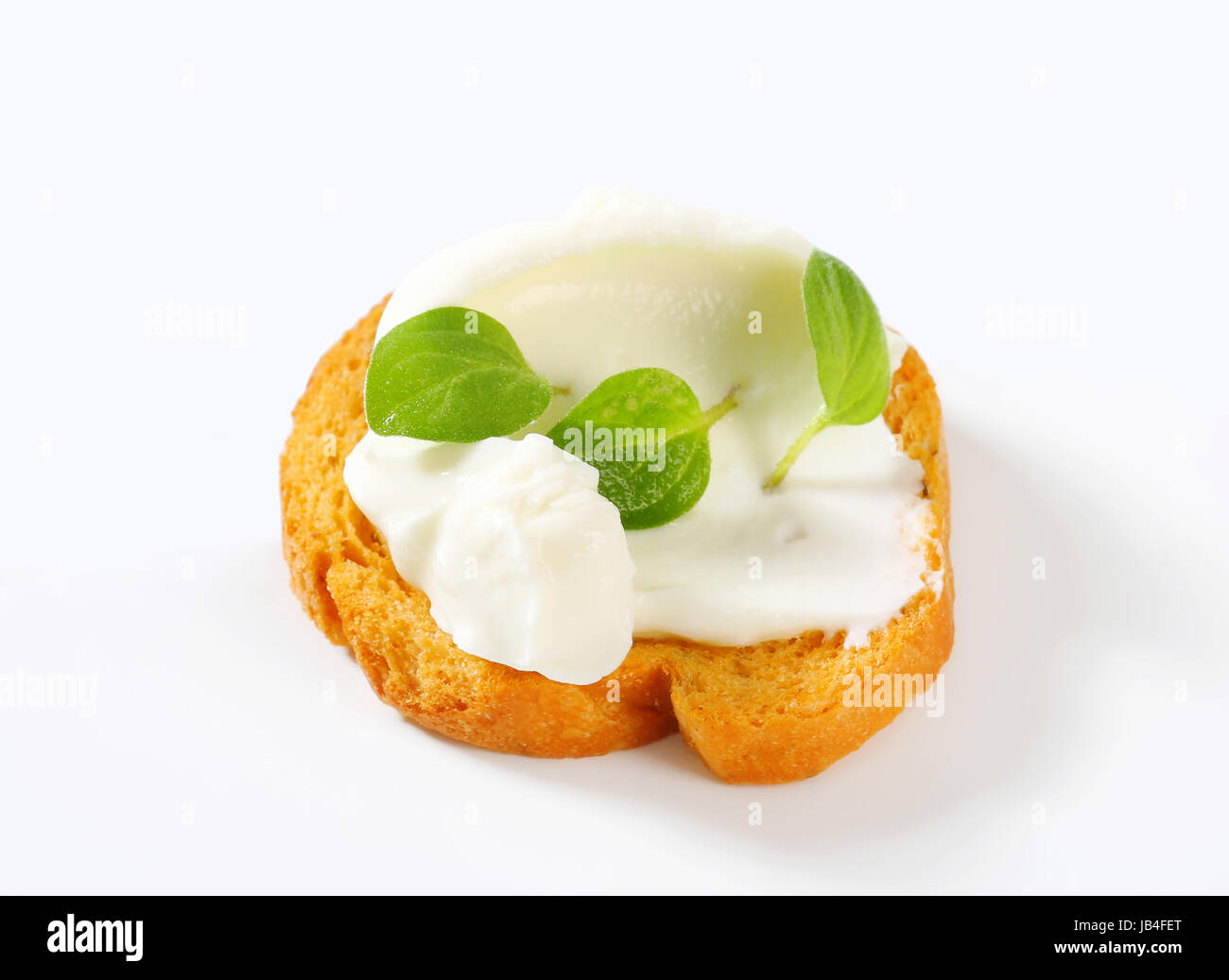 Small round toast with cheese spread Stock Photo - Alamy