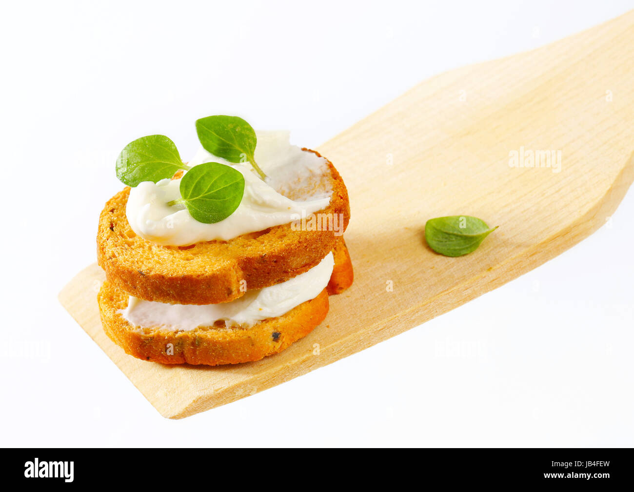 Small round toasts with cheese spread Stock Photo - Alamy