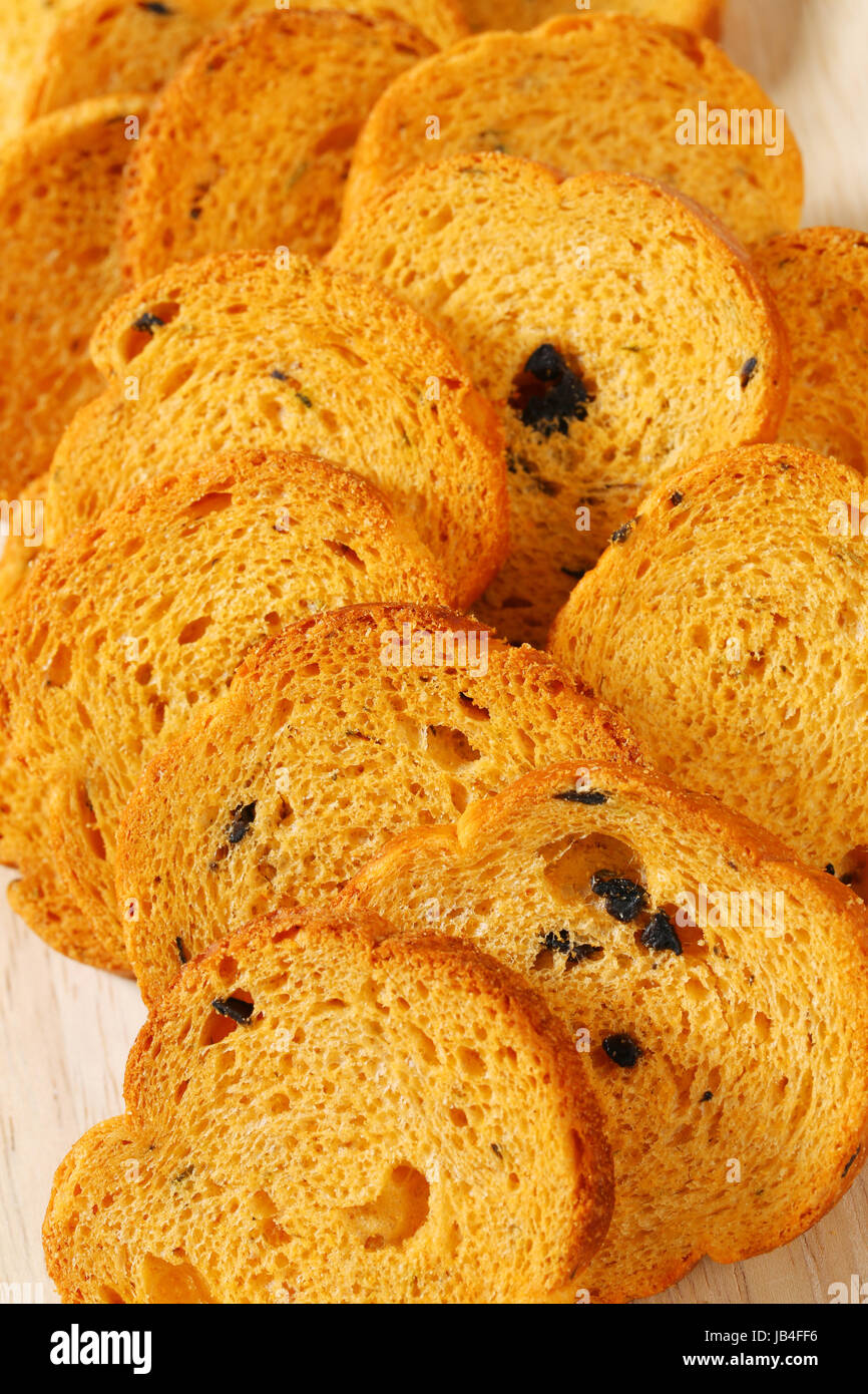 Small round toasts with black olives Stock Photo - Alamy