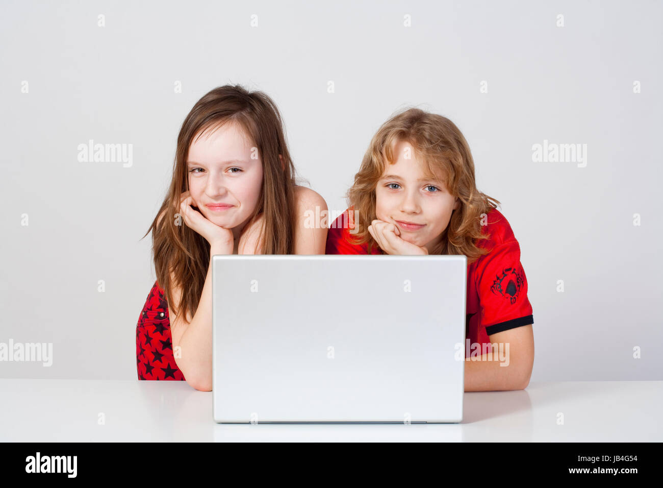 young boy and girl having fun with laptop computer Stock Photo - Alamy