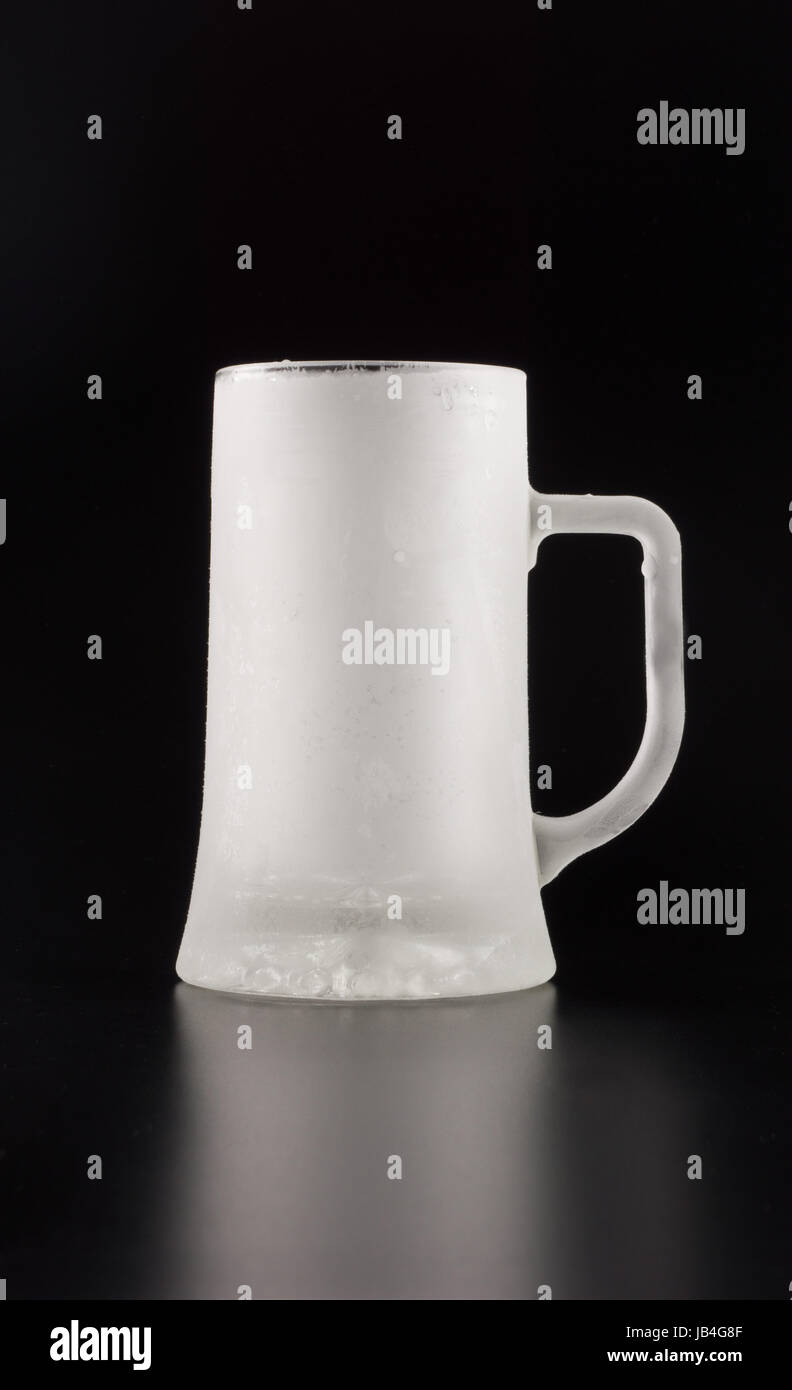 An empty and frozen glass tankard over black background Stock Photo - Alamy