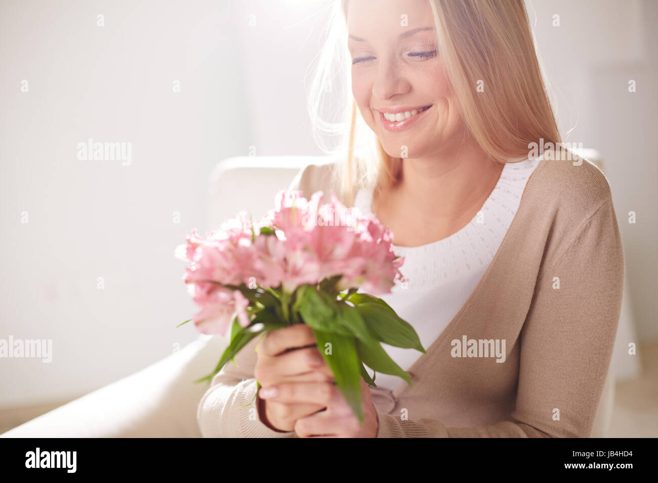 Image of smiling female holding bunch of pink lilies Stock Photo - Alamy