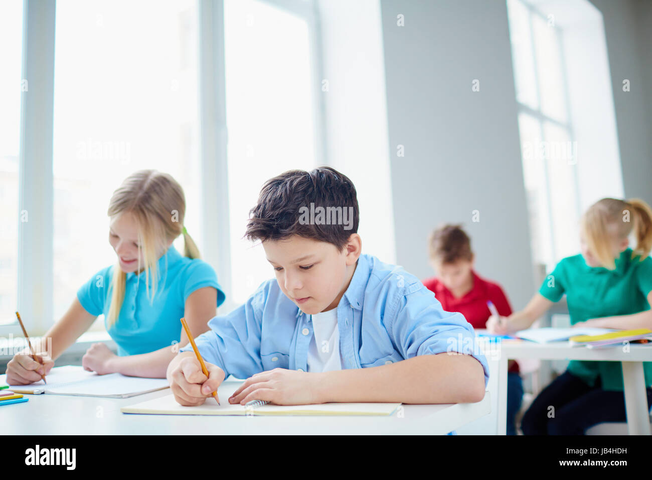Portrait of group of diligent pupils drawing at lesson Stock Photo - Alamy