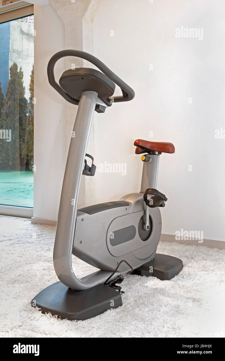 Exercise fitness equipment bike inside modern interior Stock Photo - Alamy