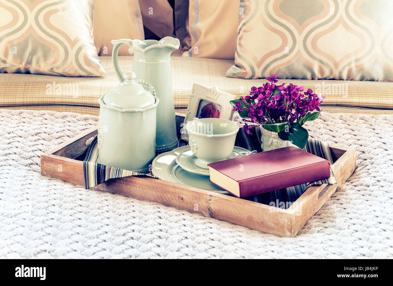 Vintage photo of decorative tray with book,tea set and flower on the ...