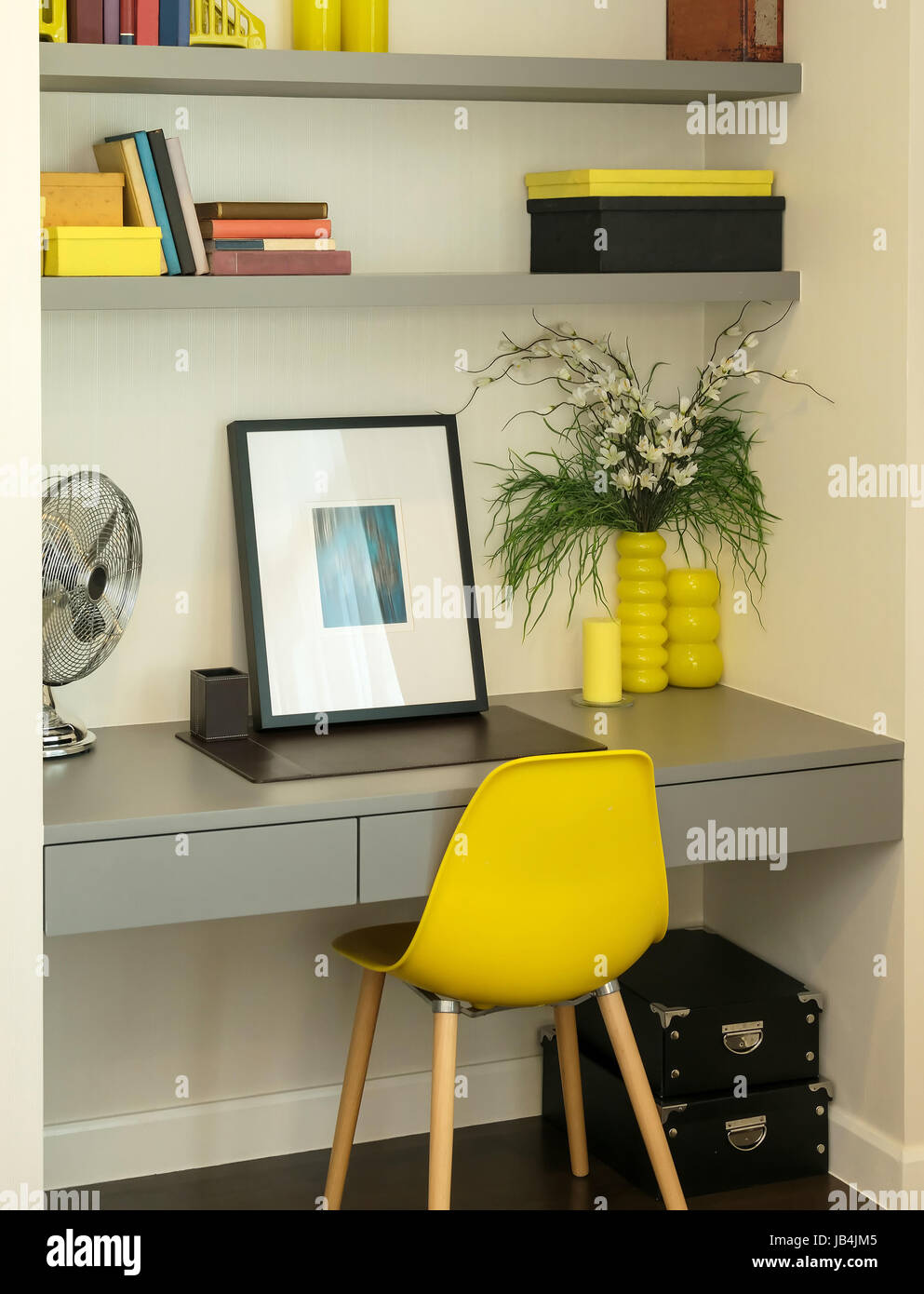 modern yellow working table with accessories on shelf Stock Photo - Alamy