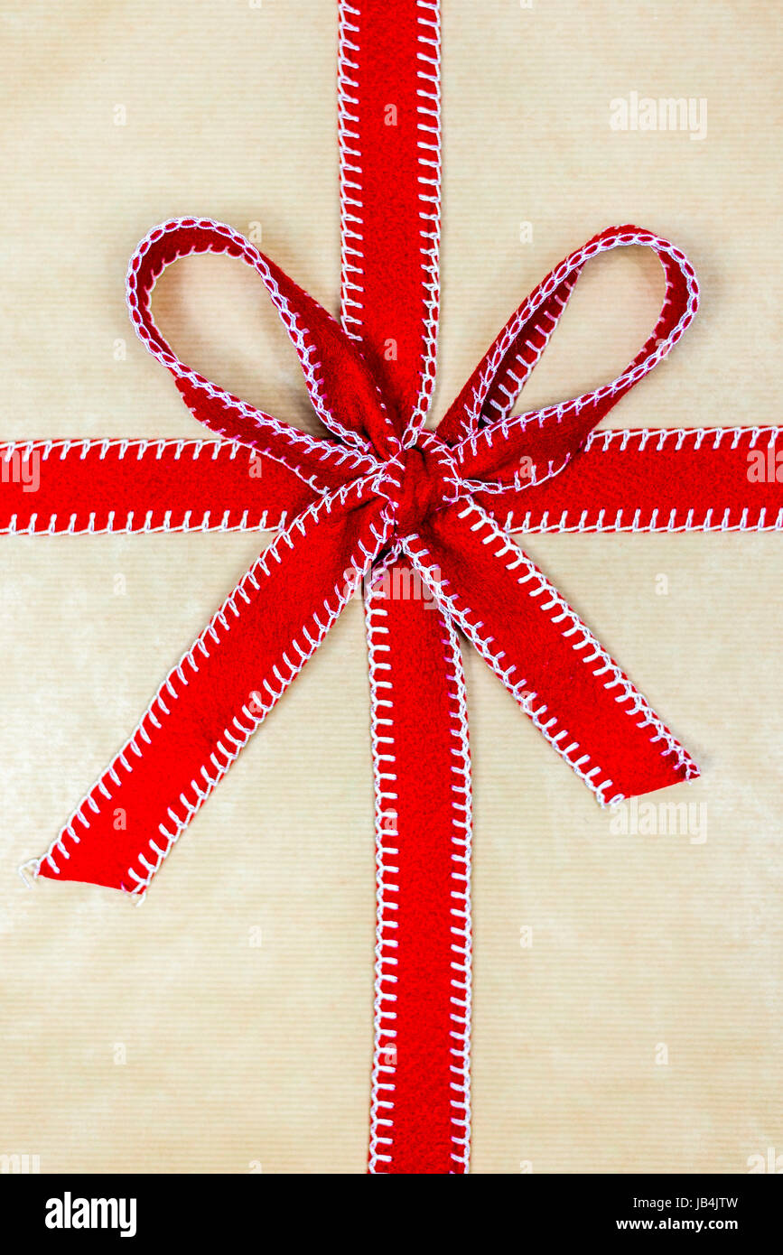 gift with red ribbon on recycled paper Stock Photo - Alamy