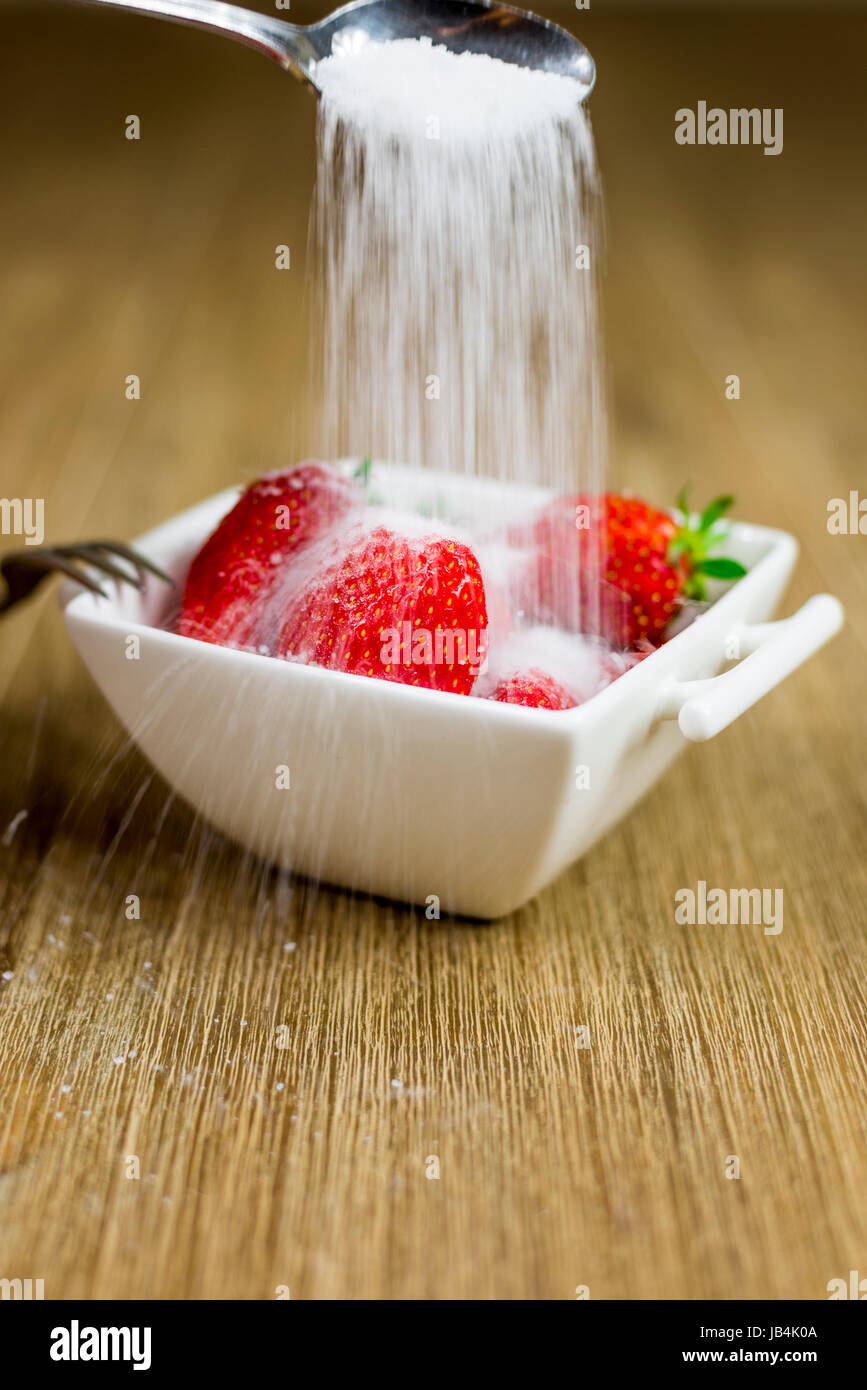 sugar being poured over strawberrys. motion blur Stock Photo - Alamy