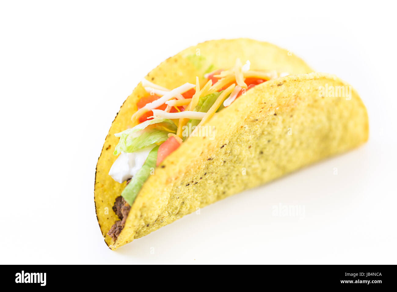 Fresh beef tacos in hard yellow corn taco shell with sour cream and ...