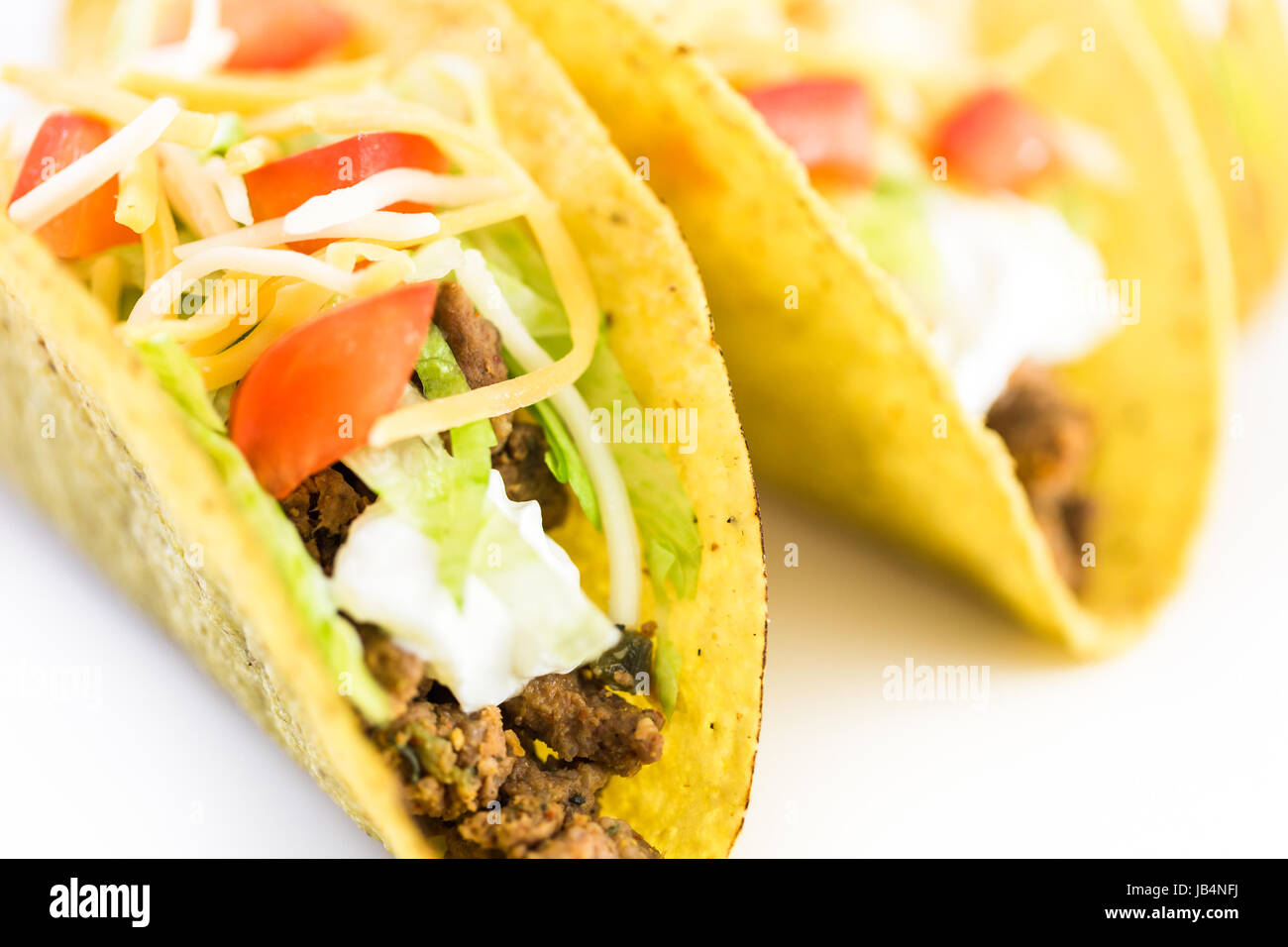 Fresh beef tacos in hard yellow corn taco shell with sour cream and ...