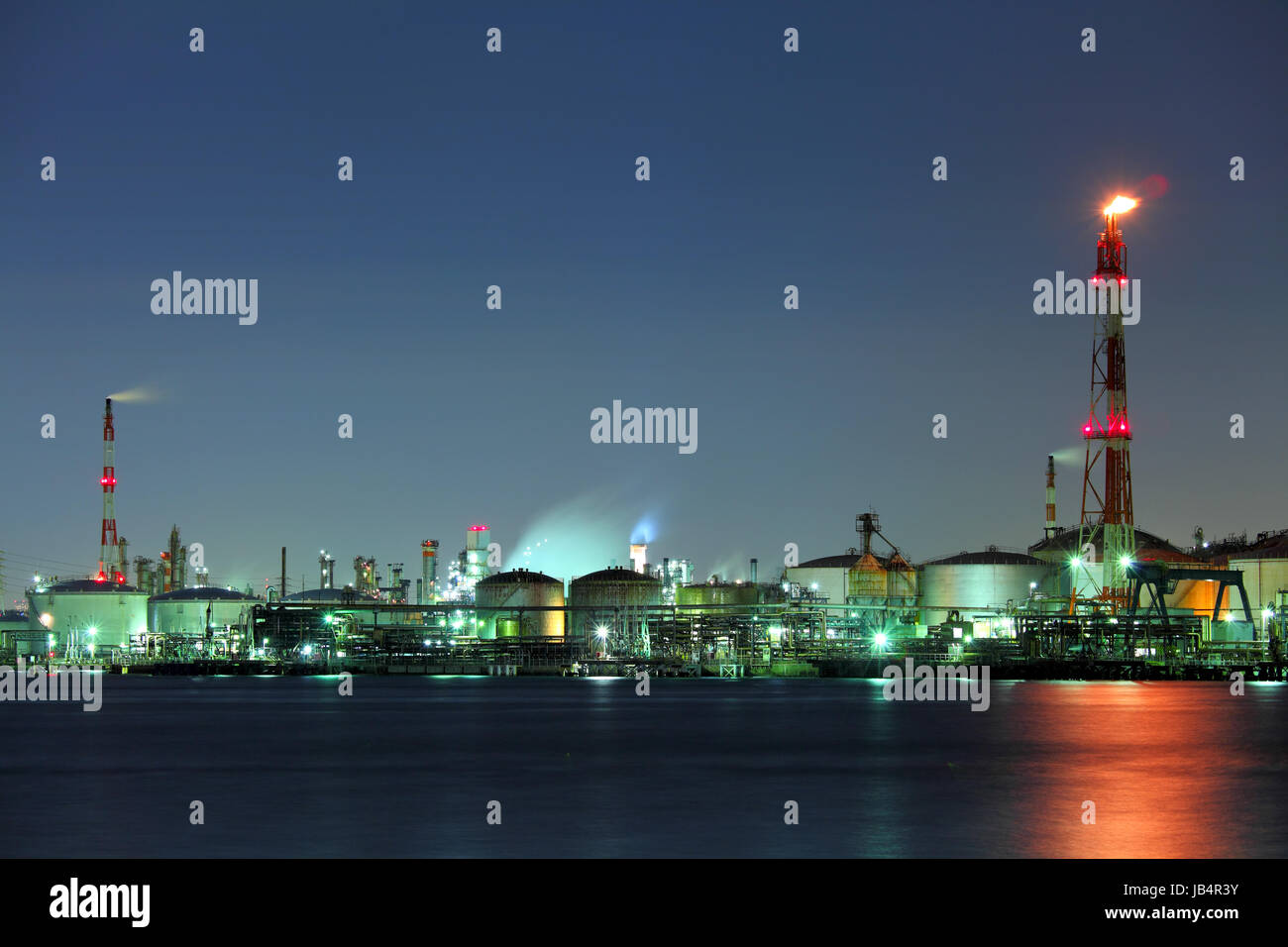 Industrial building and sea at night Stock Photo - Alamy