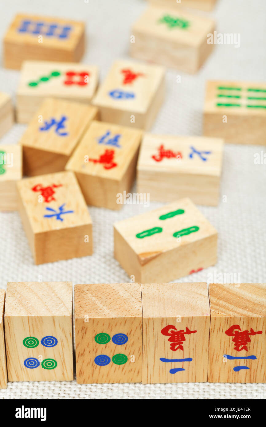 wood tiles closeup in mahjong game during playing on textile table ...
