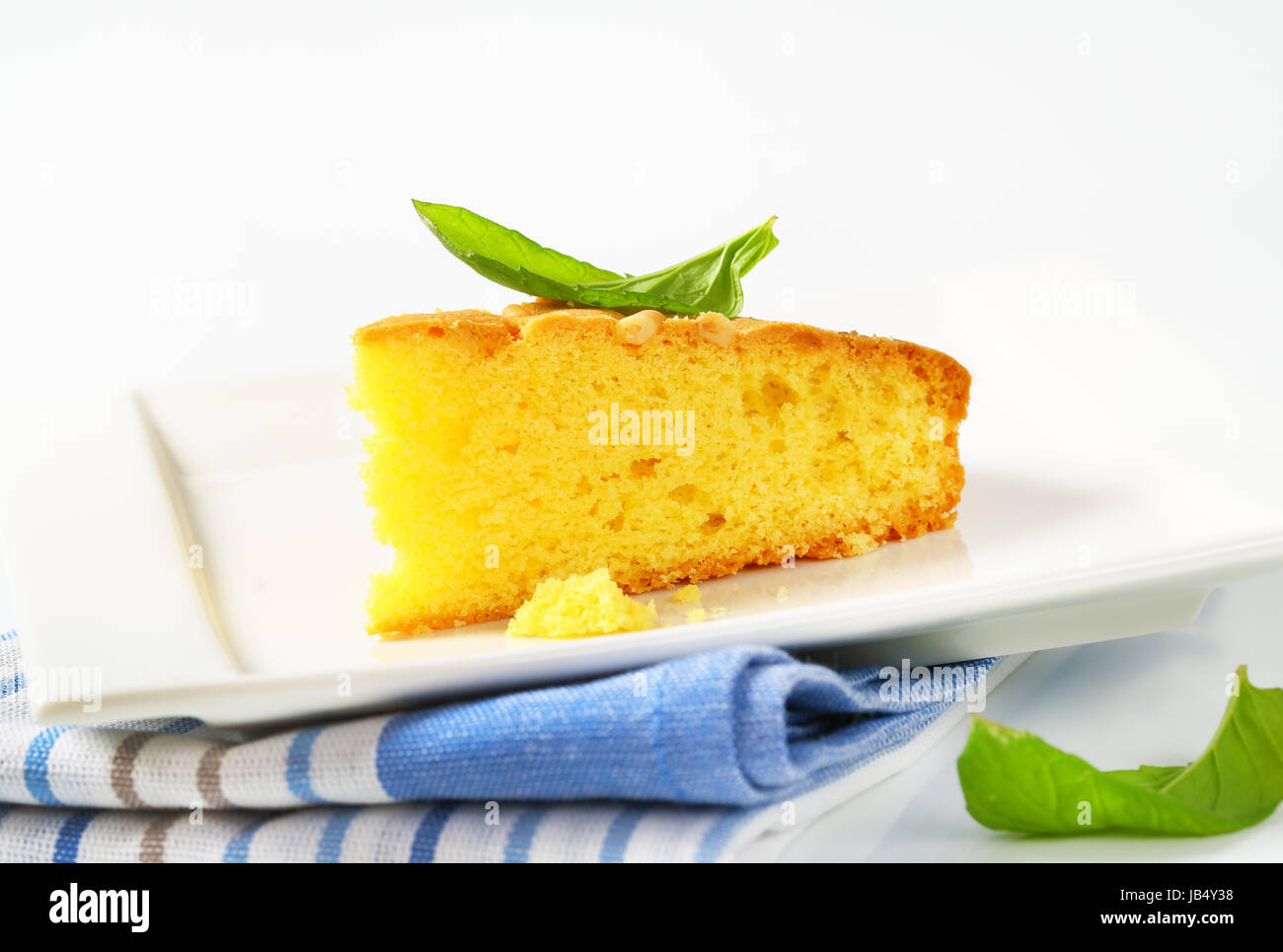 Slice of butter sponge cake on white background Stock Photo - Alamy