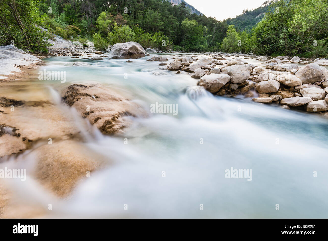 Long exposure of the water flowing rapidly trough the river, around ...