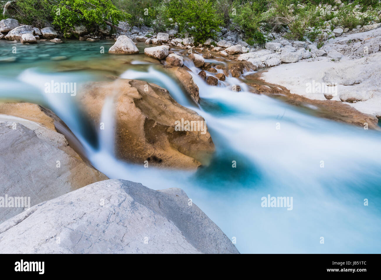 Long exposure of the water flowing rapidly trough the river, around ...