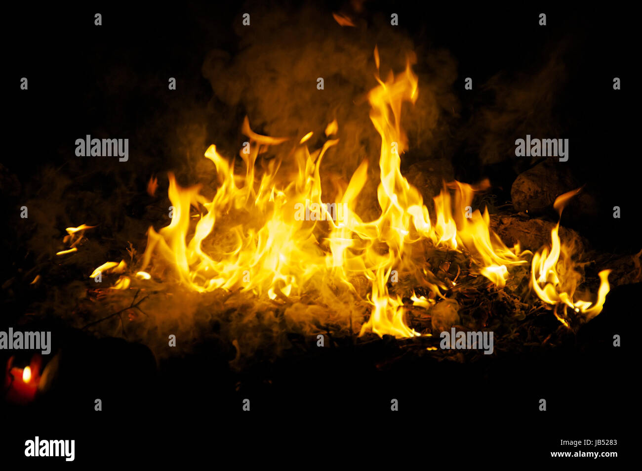 Flames and smoke fill this image of a ceremonial fire during a mayan ...