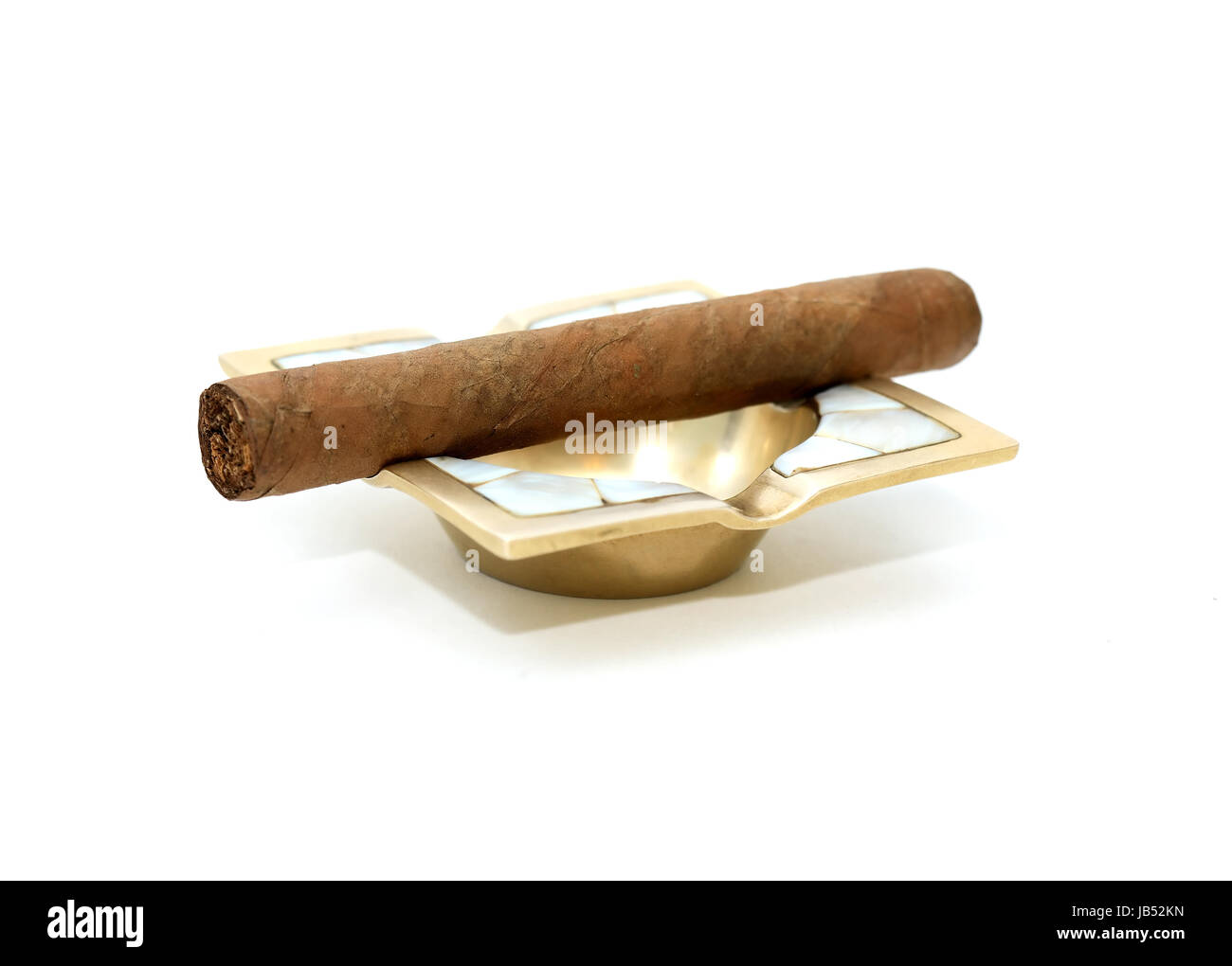 One Cuban cigar on vintage brass ashtray against white background Stock ...