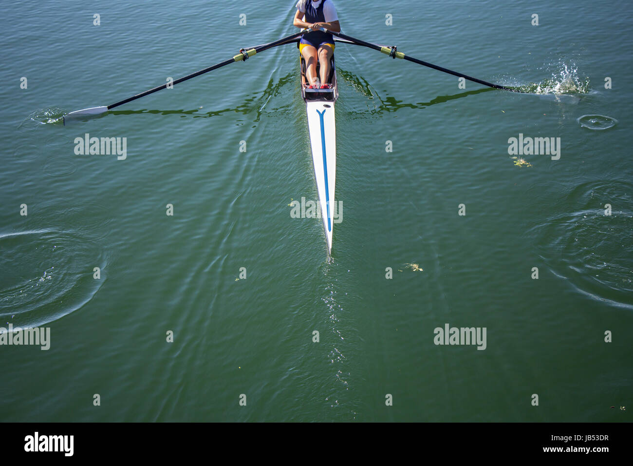 A young girl rowing in boat on water Stock Photo - Alamy