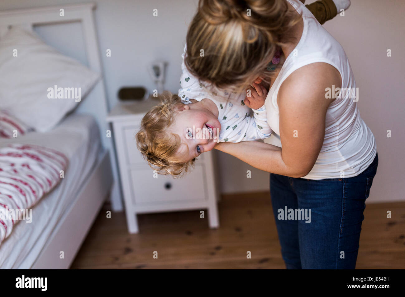 Young mother at home holding her cute little son Stock Photo - Alamy