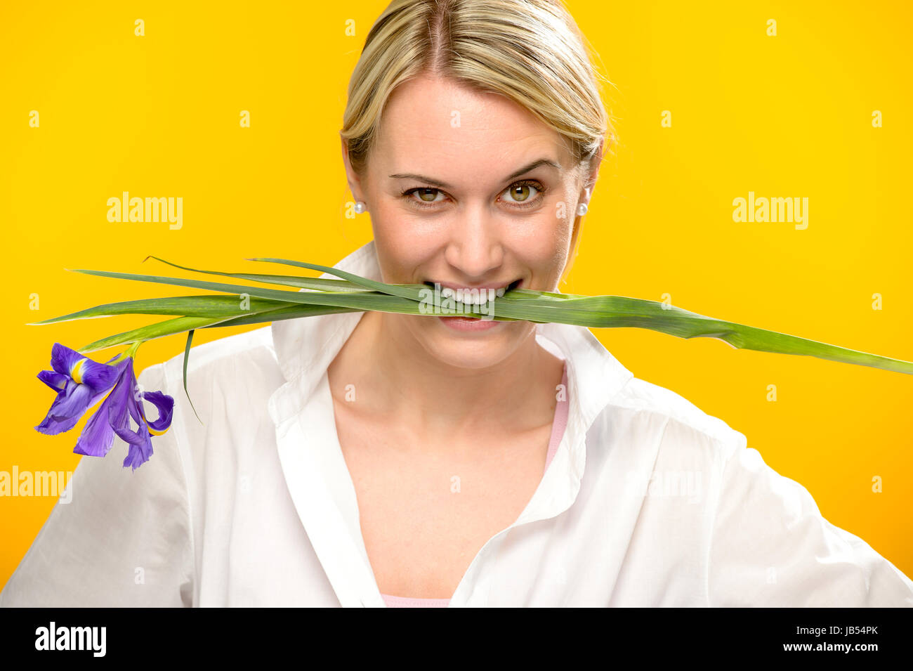 Woman with blue spring iris flower bite between her teeth Stock Photo ...