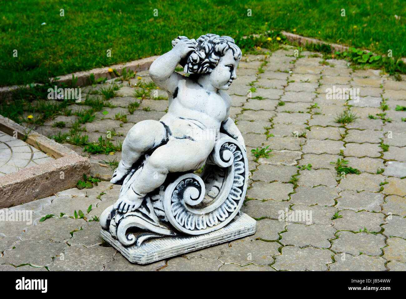 Sculpture of an angel sitting on a chair. Beautiful sculpture in the ...