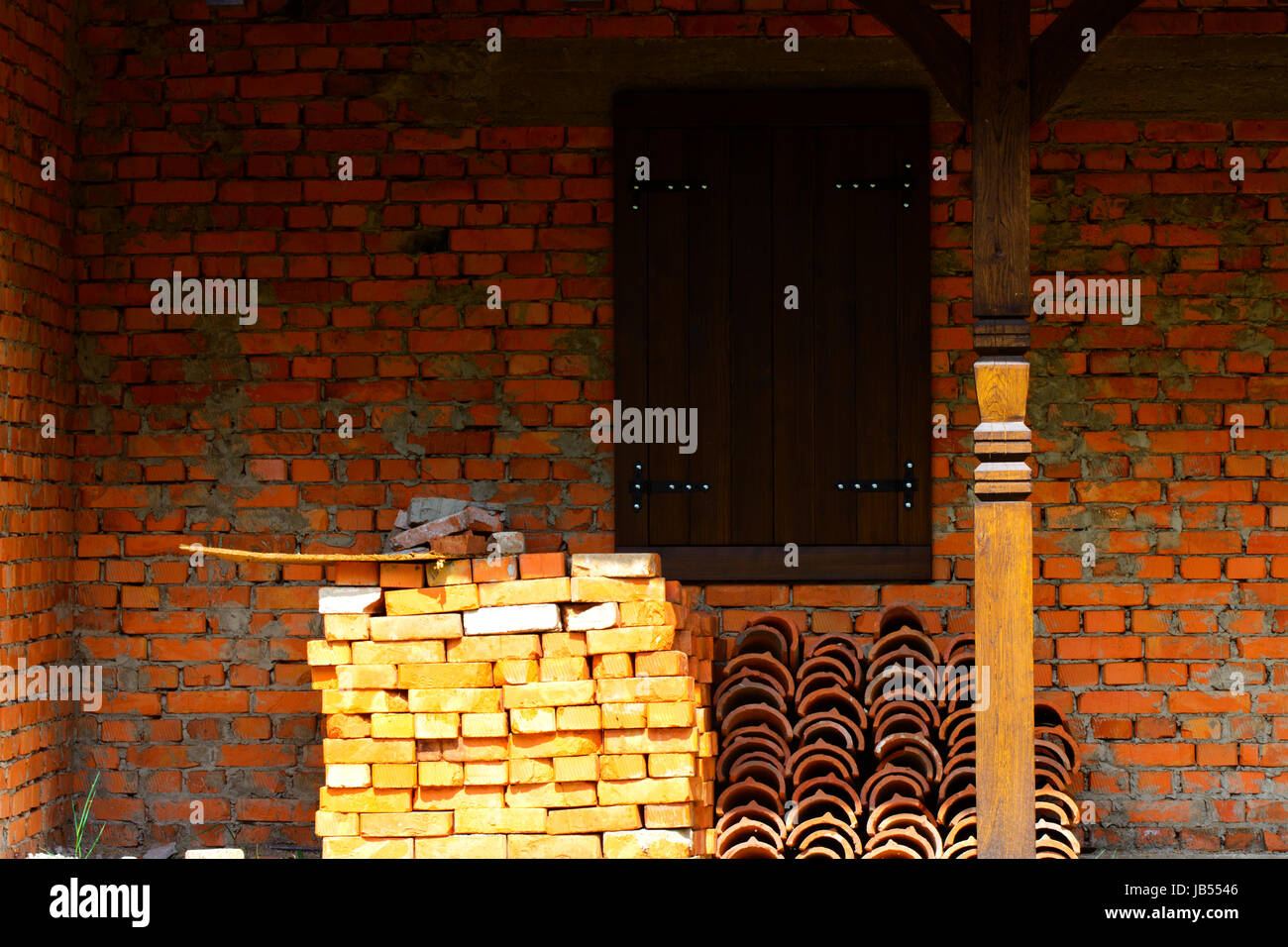 Unfinished house with a tiled roof in the village Stock Photo - Alamy