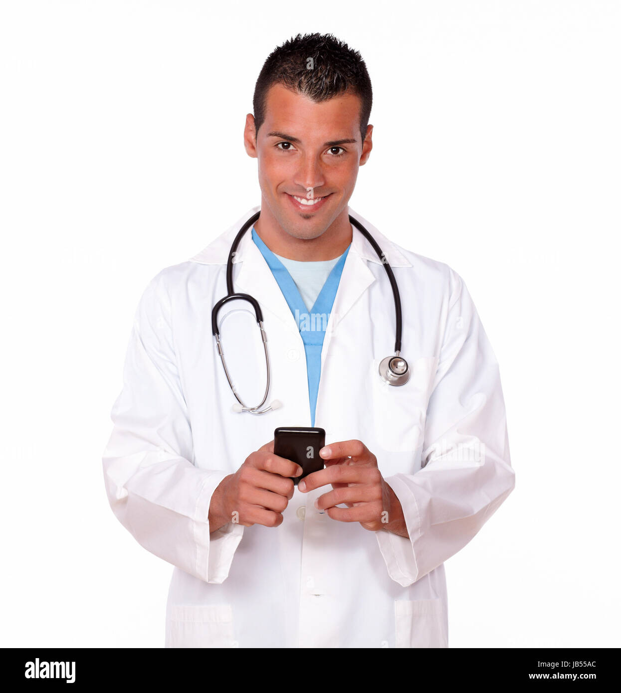 Portrait of handsome 20s male doctor sending a message with his mobile ...