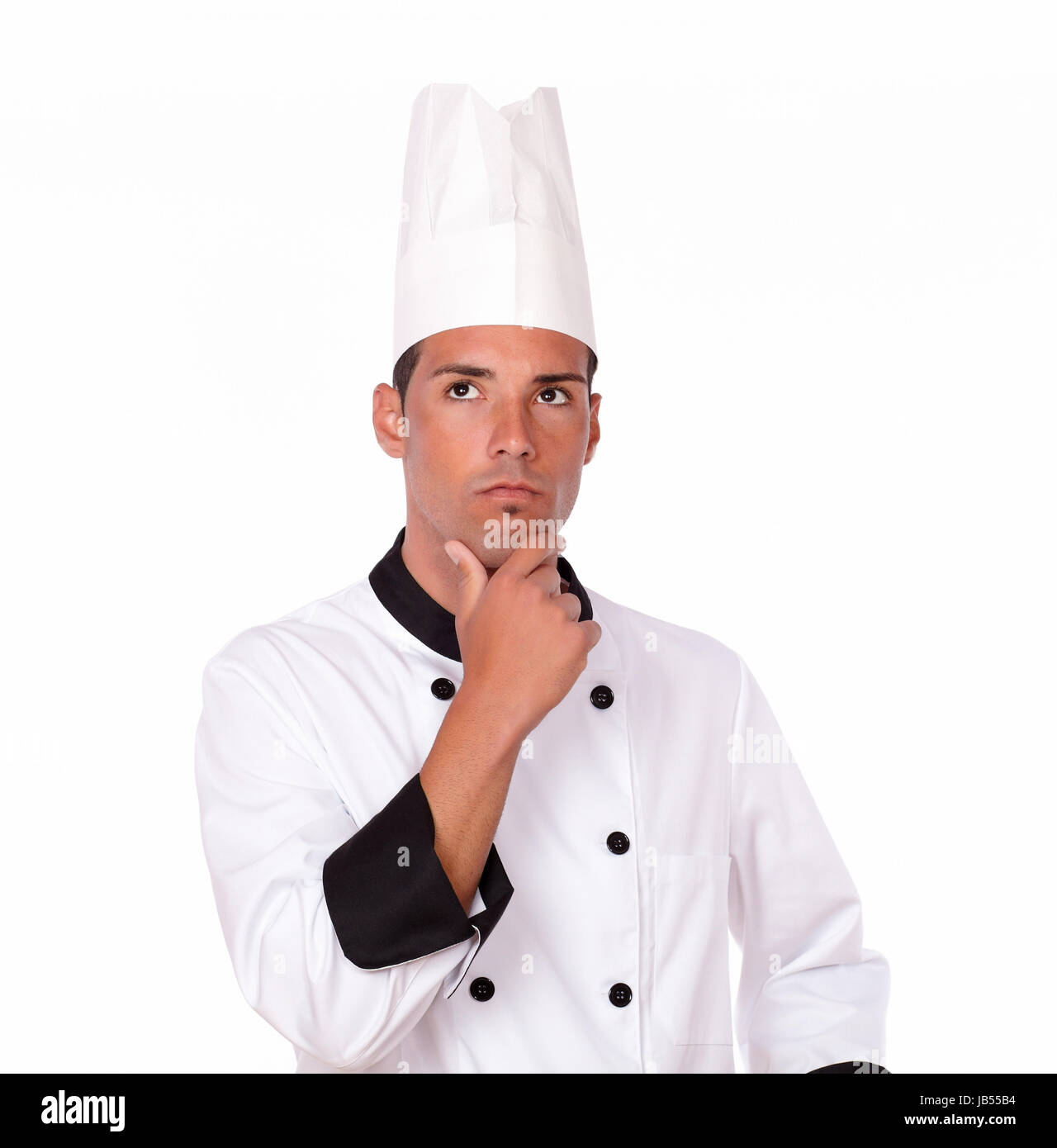 Portrait of reflective latin chef on white uniform standing and looking ...