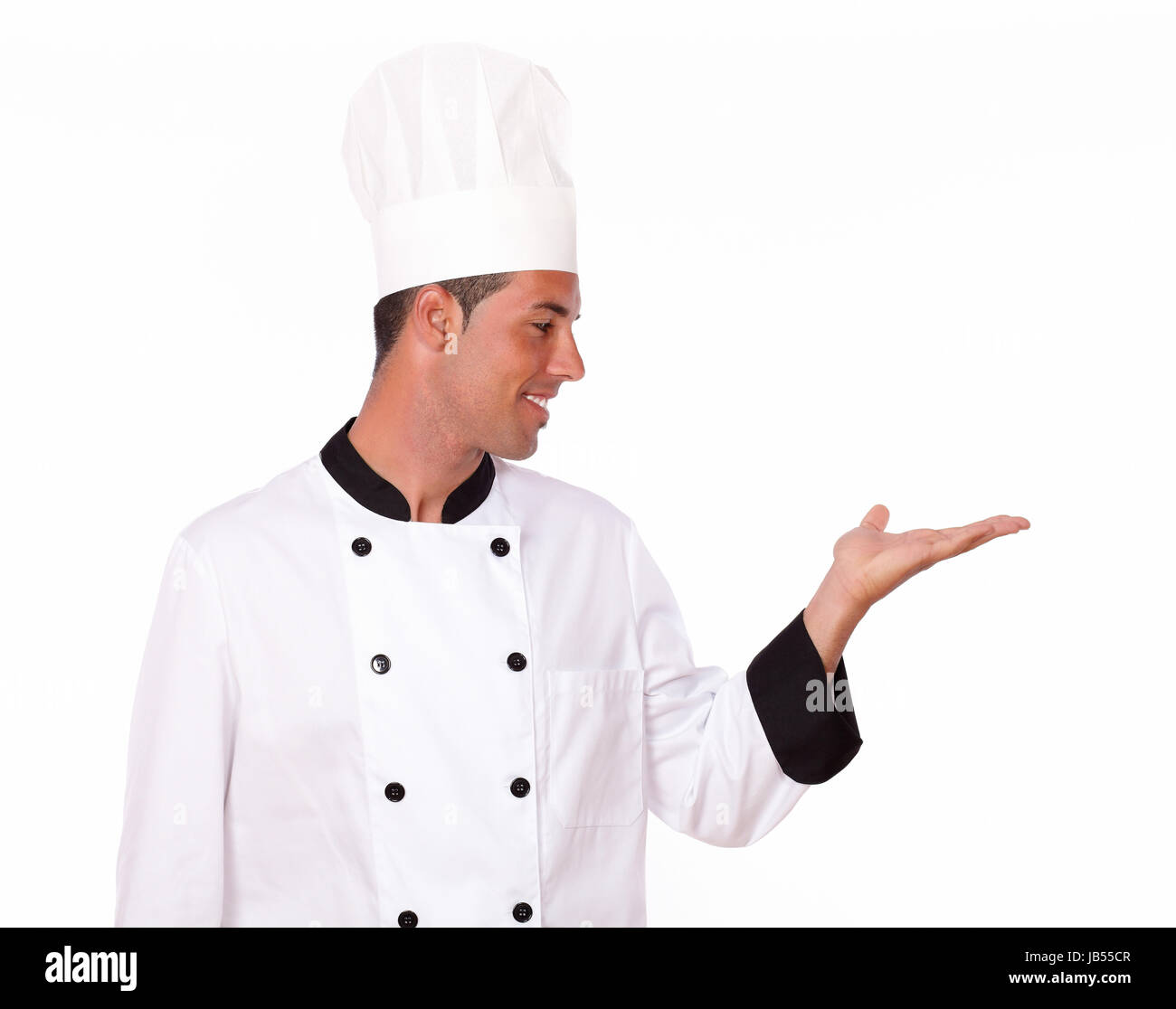 Portrait of charming chef on white uniform holding up his left palm ...