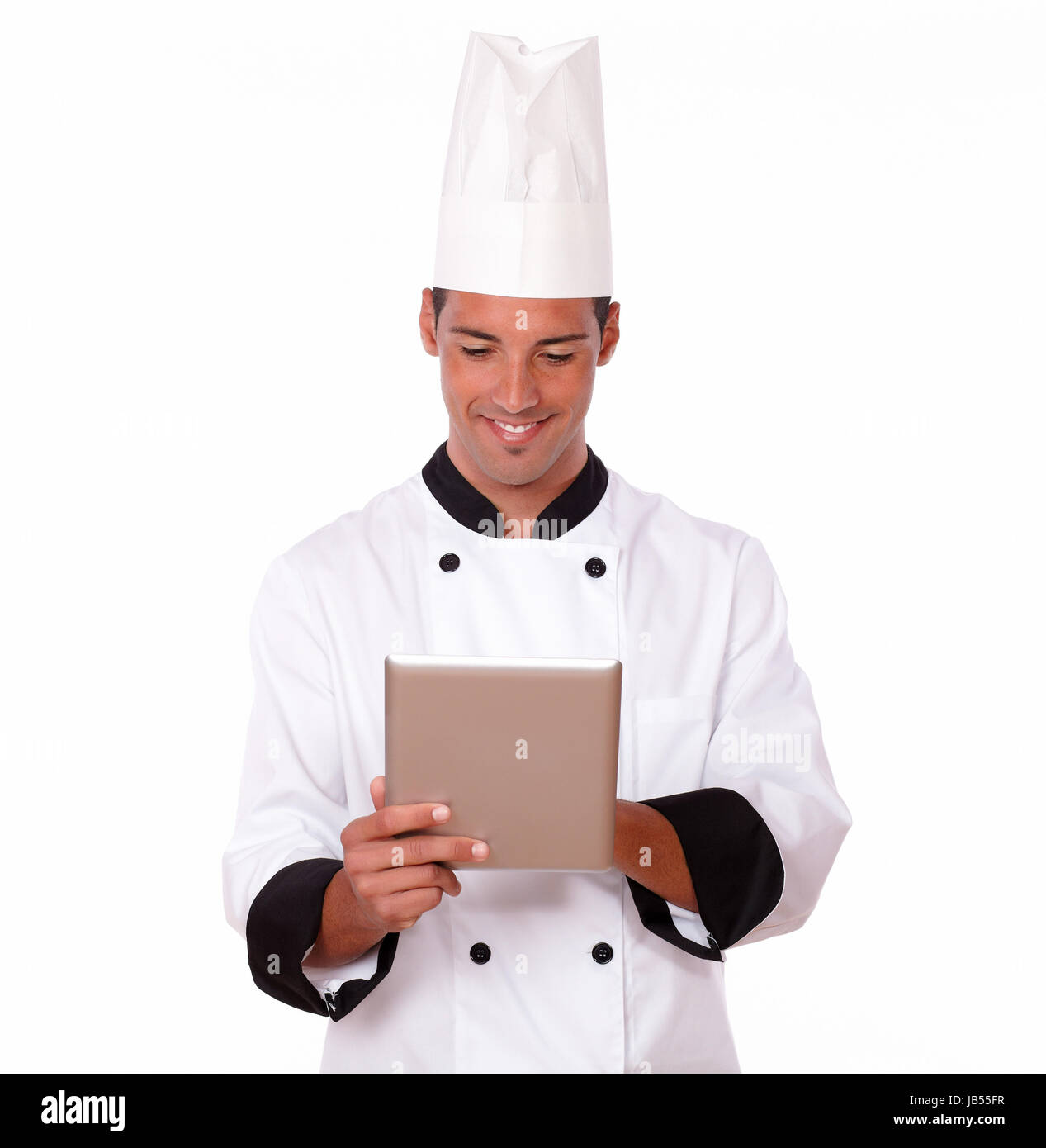 Portrait of handsome latin chef on white uniform using his tablet pc ...