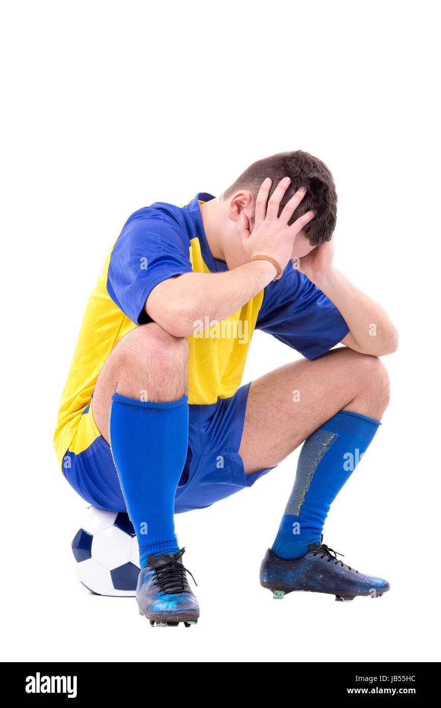Defeated football player with ball isolated in white Stock Photo - Alamy