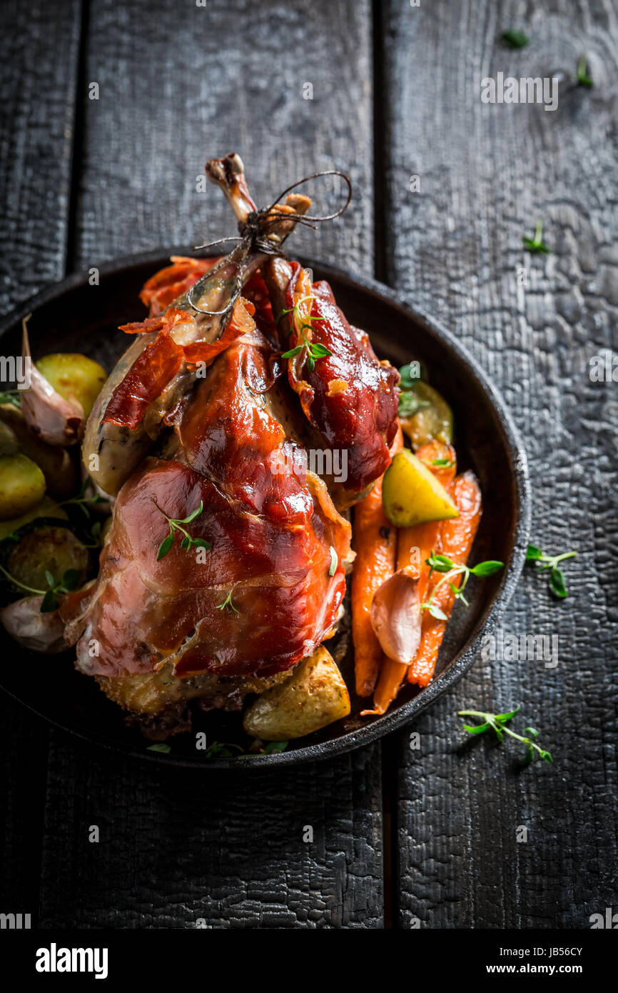 Grilled pheasant with bacon and vegetables on dark background Stock ...