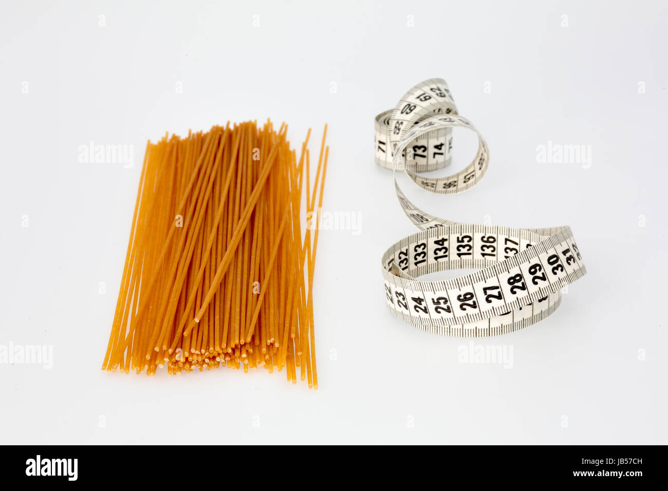 Weight loss concept with healthy whole-grain spaghetti and measuring ...