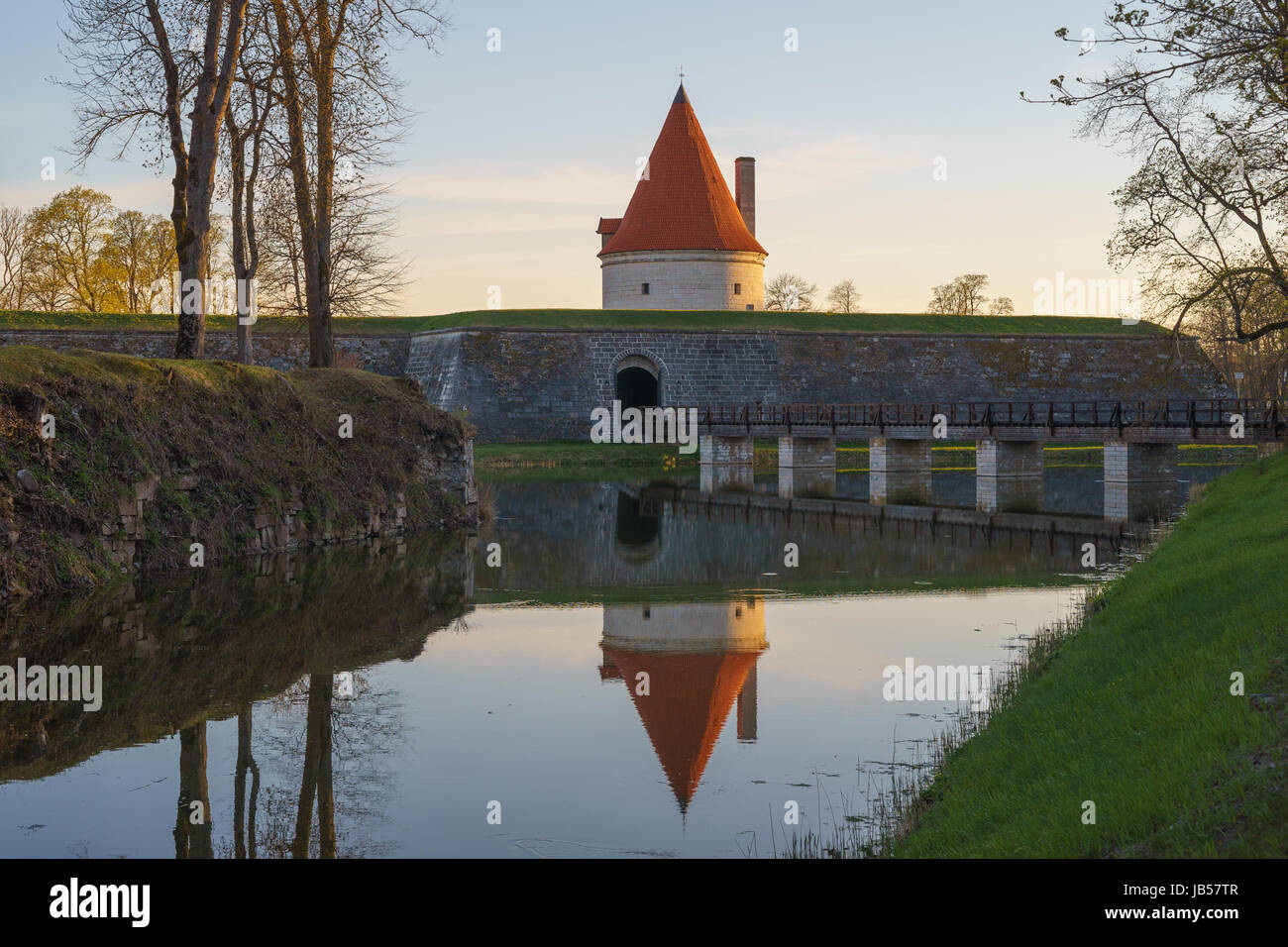 Kuressaare castle tower with bridge over the moat in sunset light ...