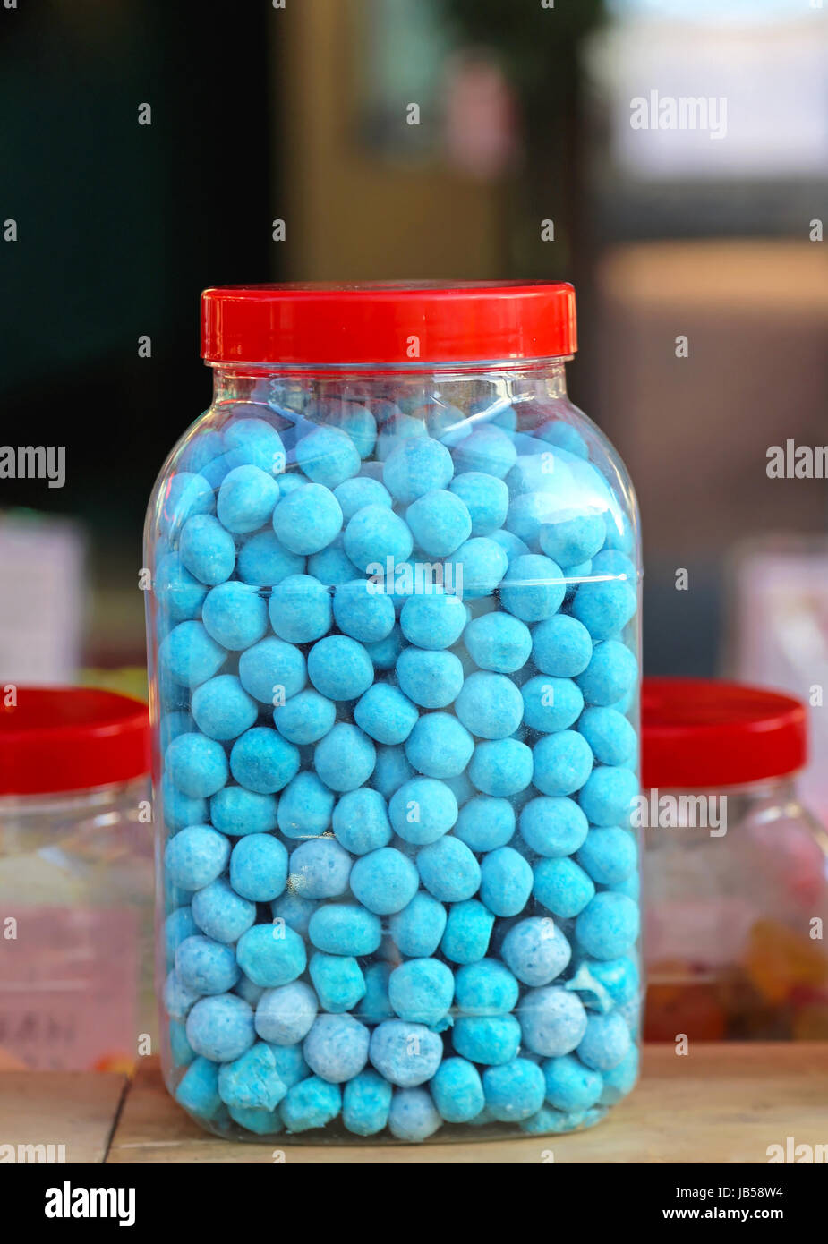 Big jar full of blue candy sweets Stock Photo - Alamy