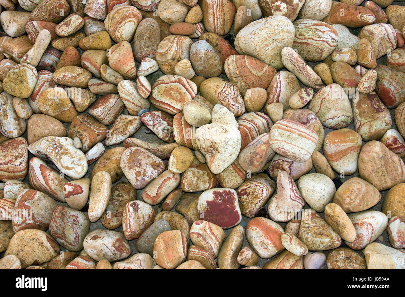 red striped sandy pebbles on a beach in ireland Stock Photo - Alamy