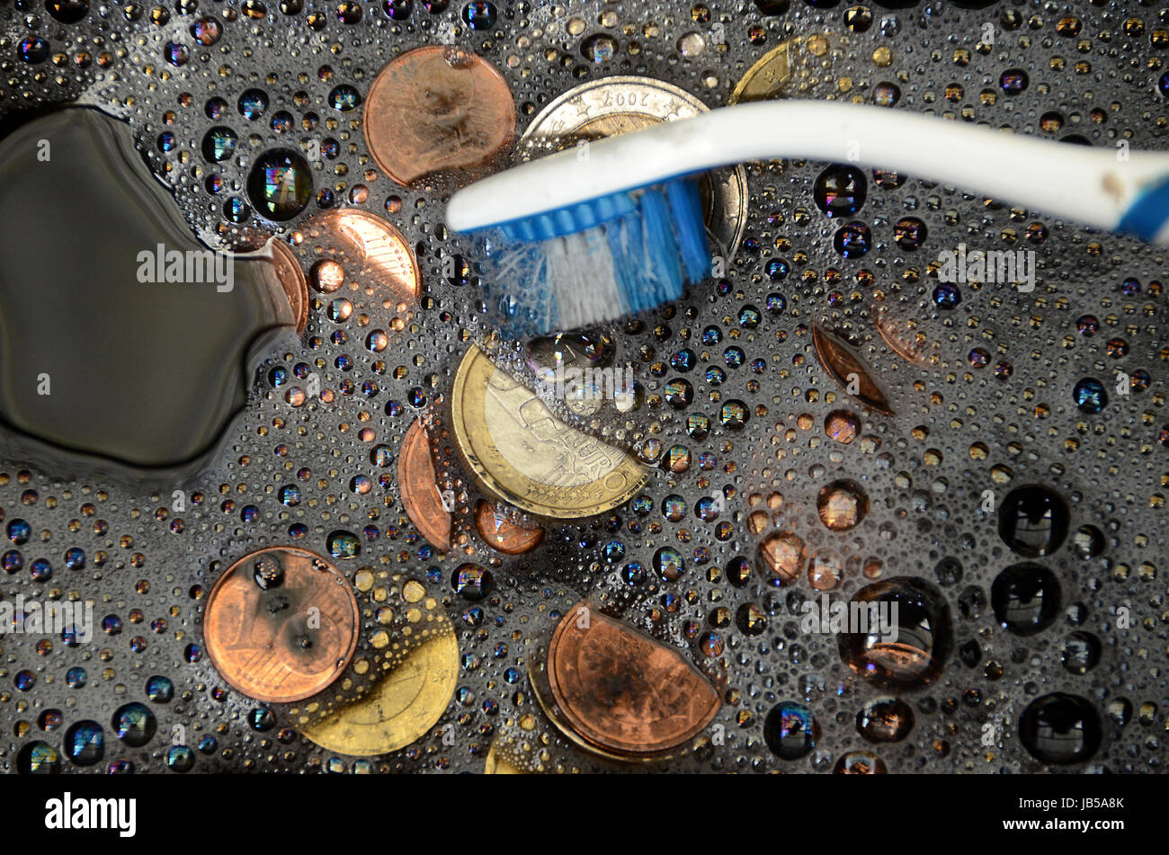 Black Euro coins being washed, suggesting the term "whitewash of black ...