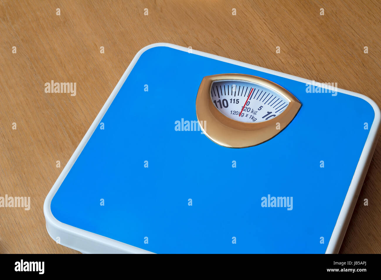 Comfortable scales blue for weighing. Located on the wooden floor Stock ...
