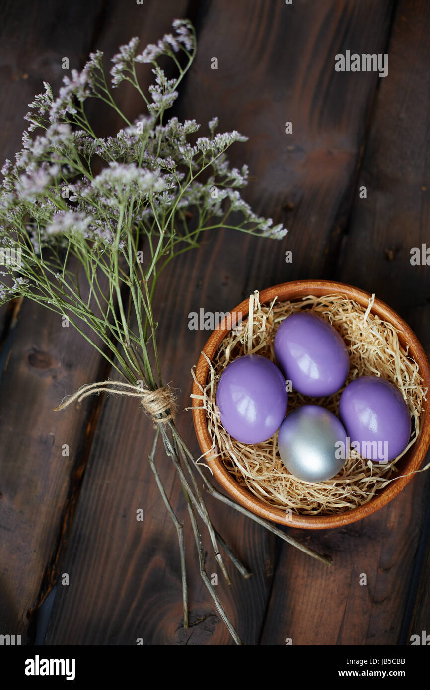 Colorful Easter eggs and dry flowers near by Stock Photo - Alamy