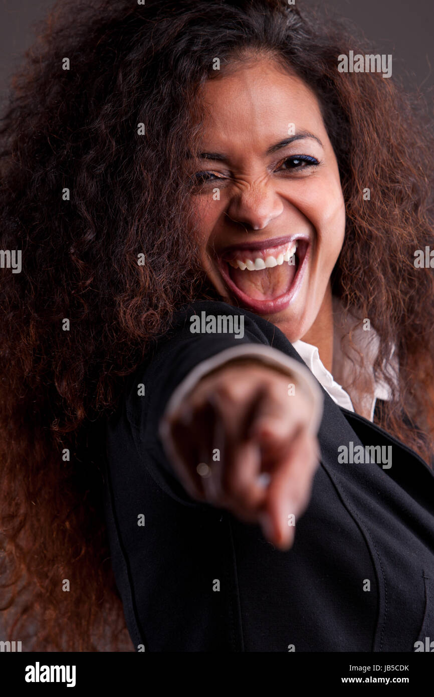 Beautiful smiling woman pointing finger Stock Photo - Alamy