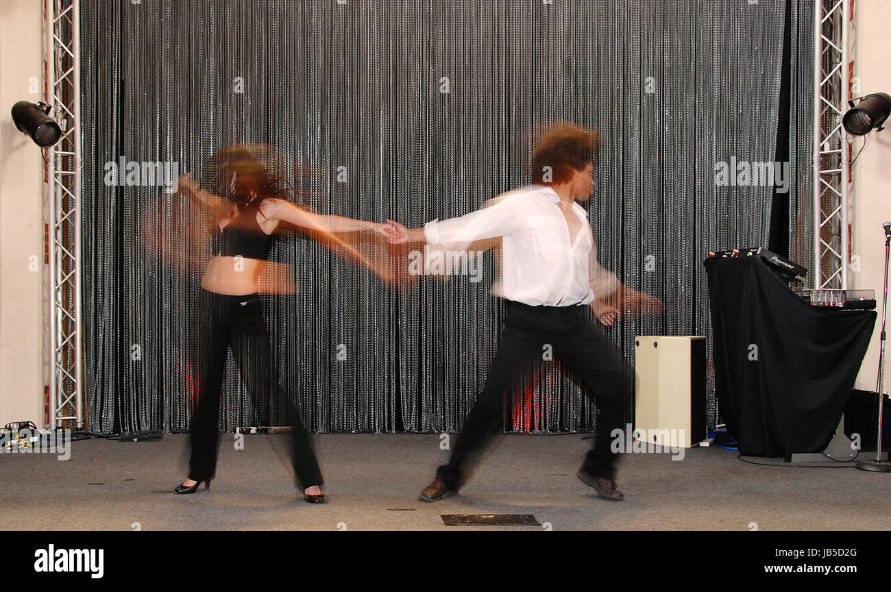 Two dancers on a stage with motion blur Stock Photo - Alamy
