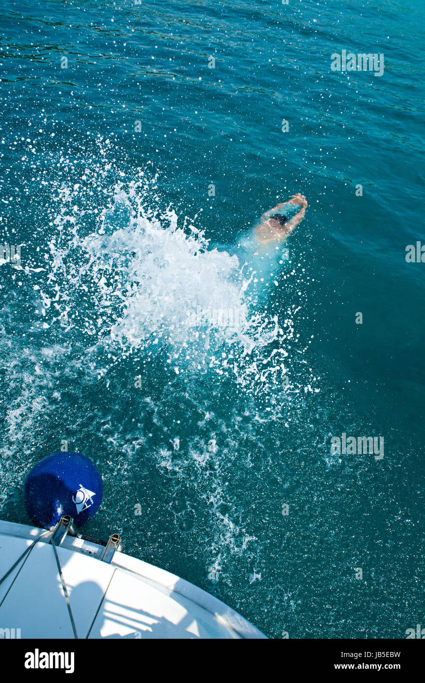 Swimmer jumping into sea from yacht during summer Stock Photo - Alamy