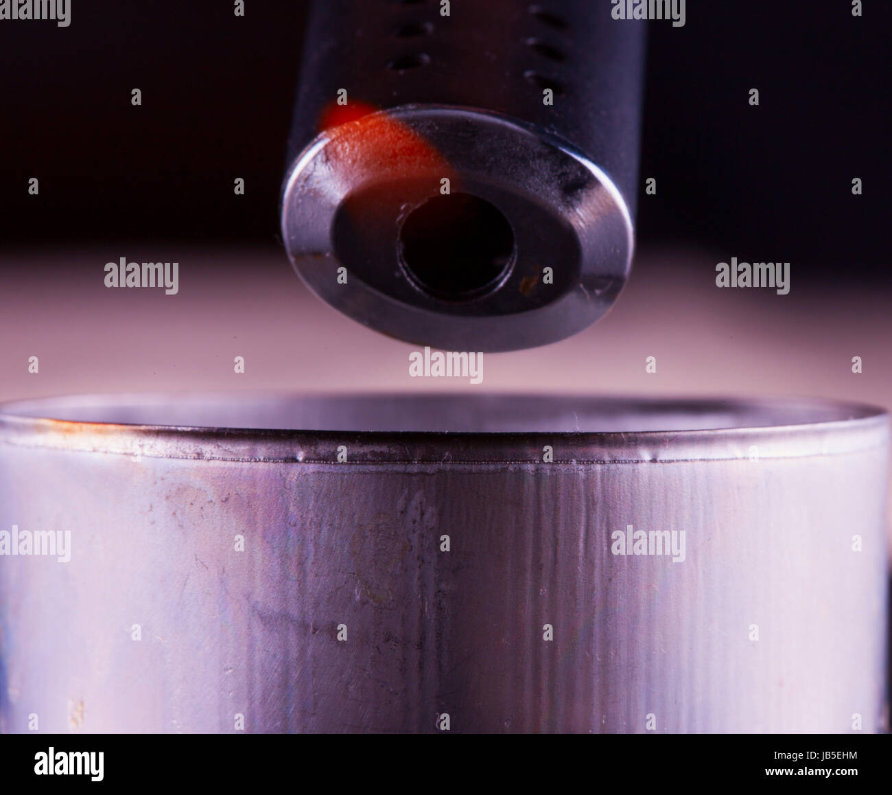 Black lighter with lit flame near a candle, close up Stock Photo - Alamy